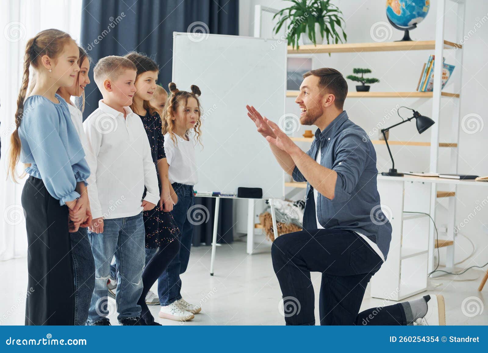 Storyteller with Interesting Information. Group of Children Students in ...