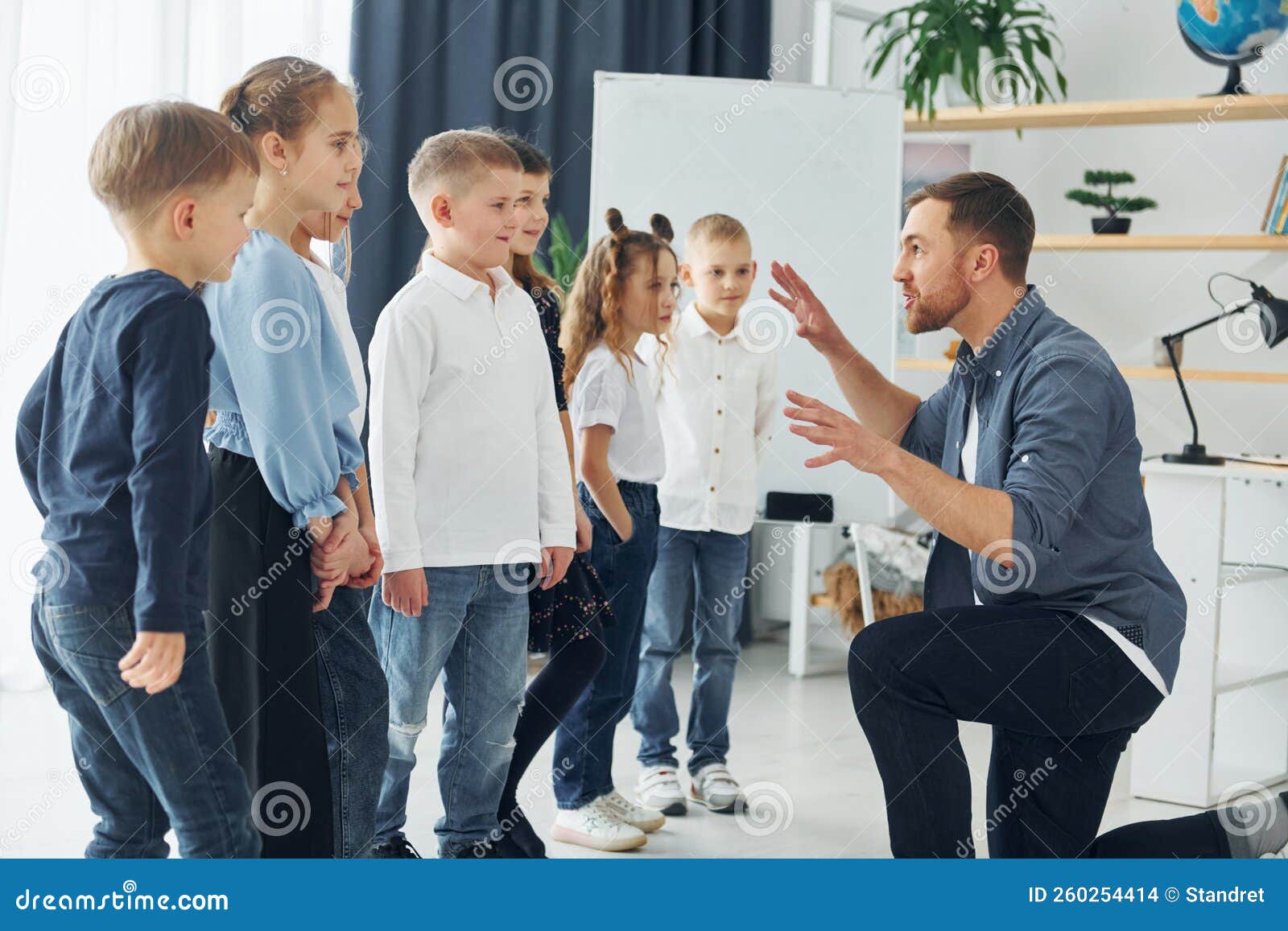 Storyteller with Interesting Information. Group of Children Students in ...