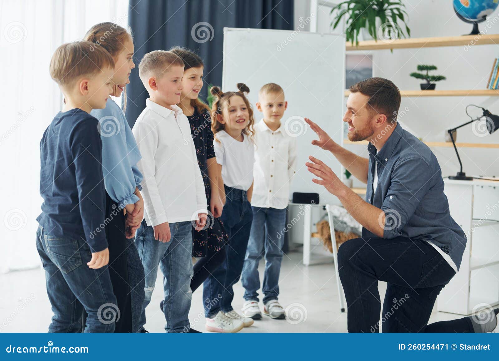 Storyteller with Interesting Information. Group of Children Students in ...