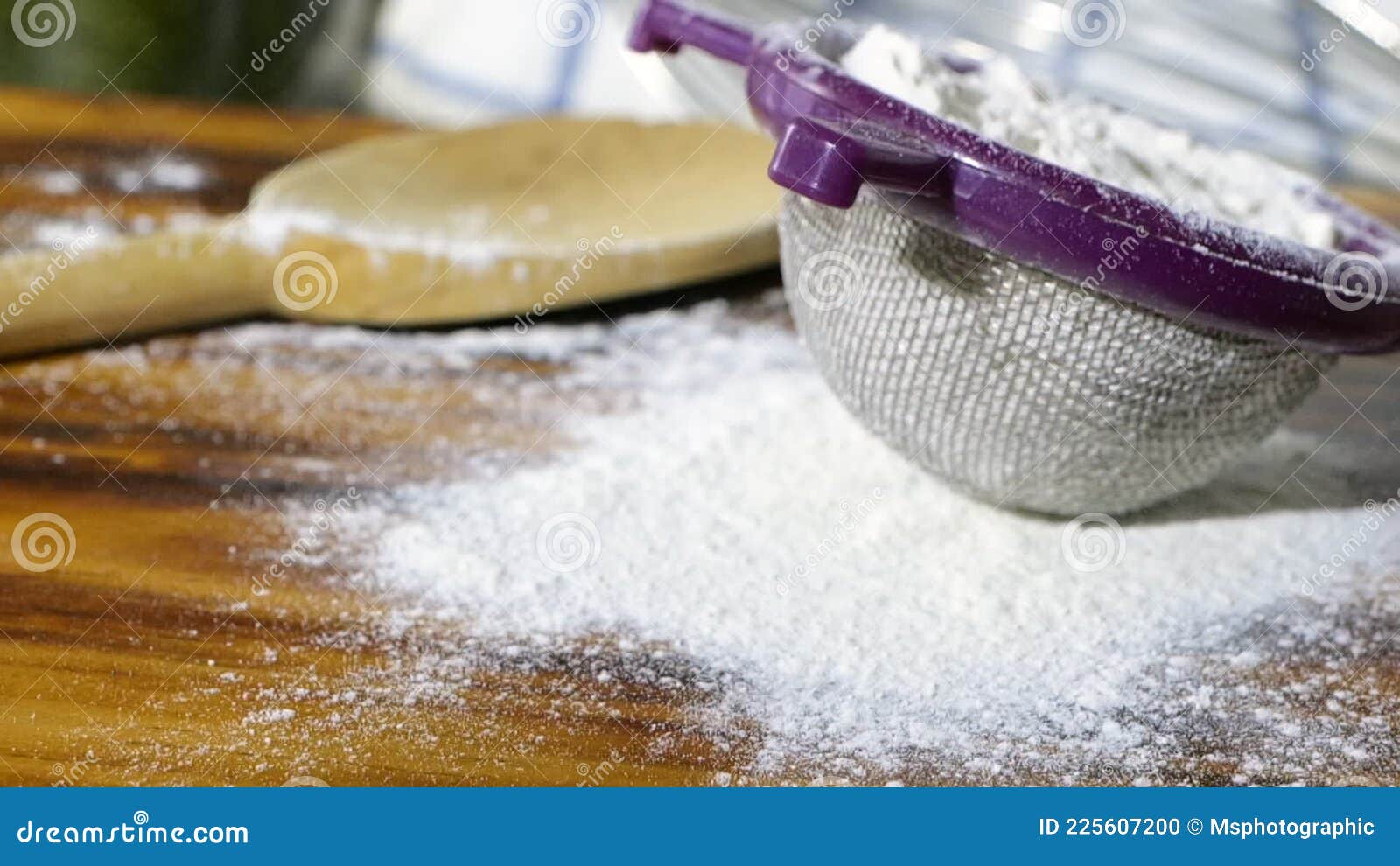 A Strainer Full of White Flour Falling Onto a Cutting Board Stock ...