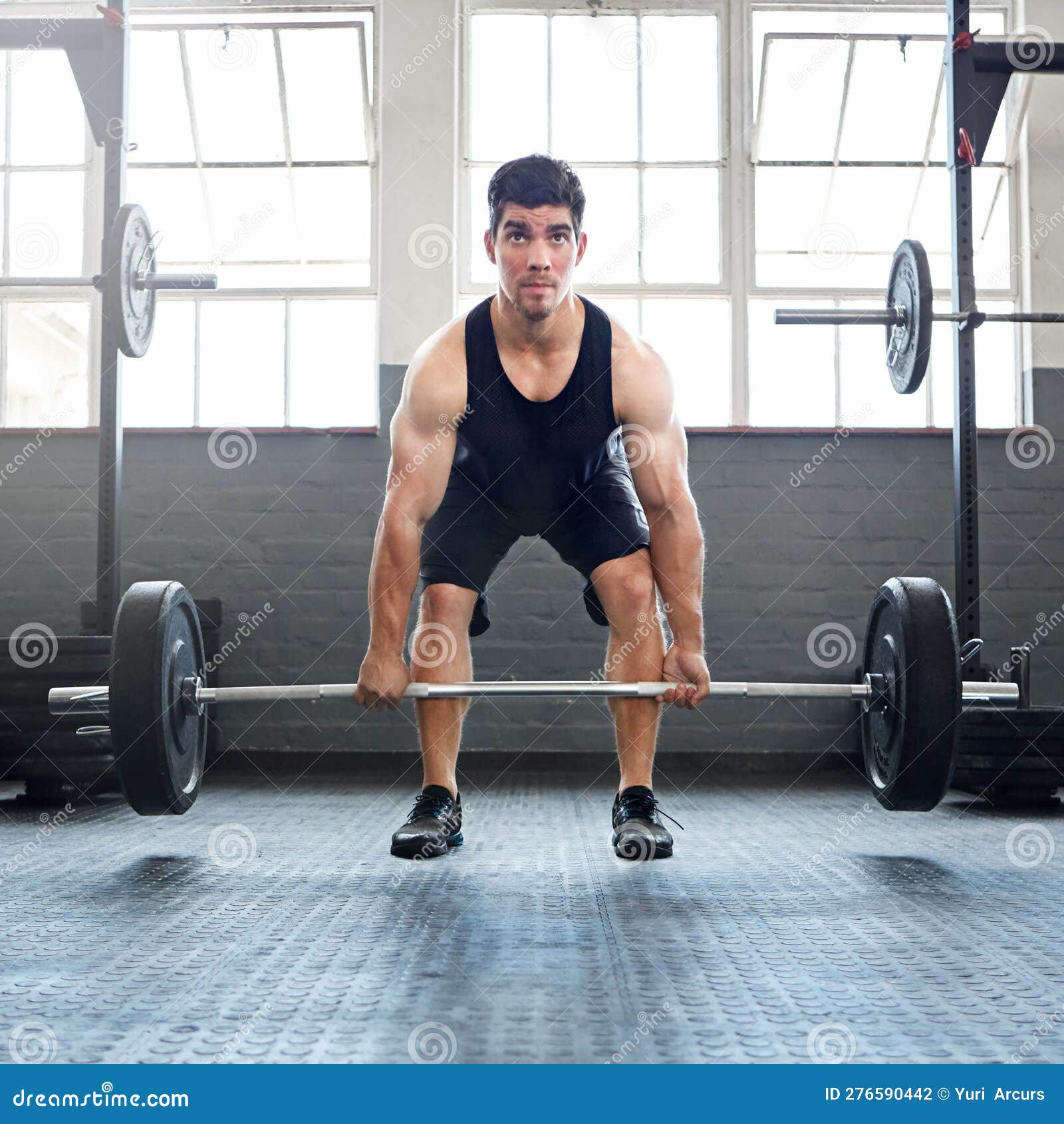 Straining through the Lift. a Young Man Working Out with Weights in the ...