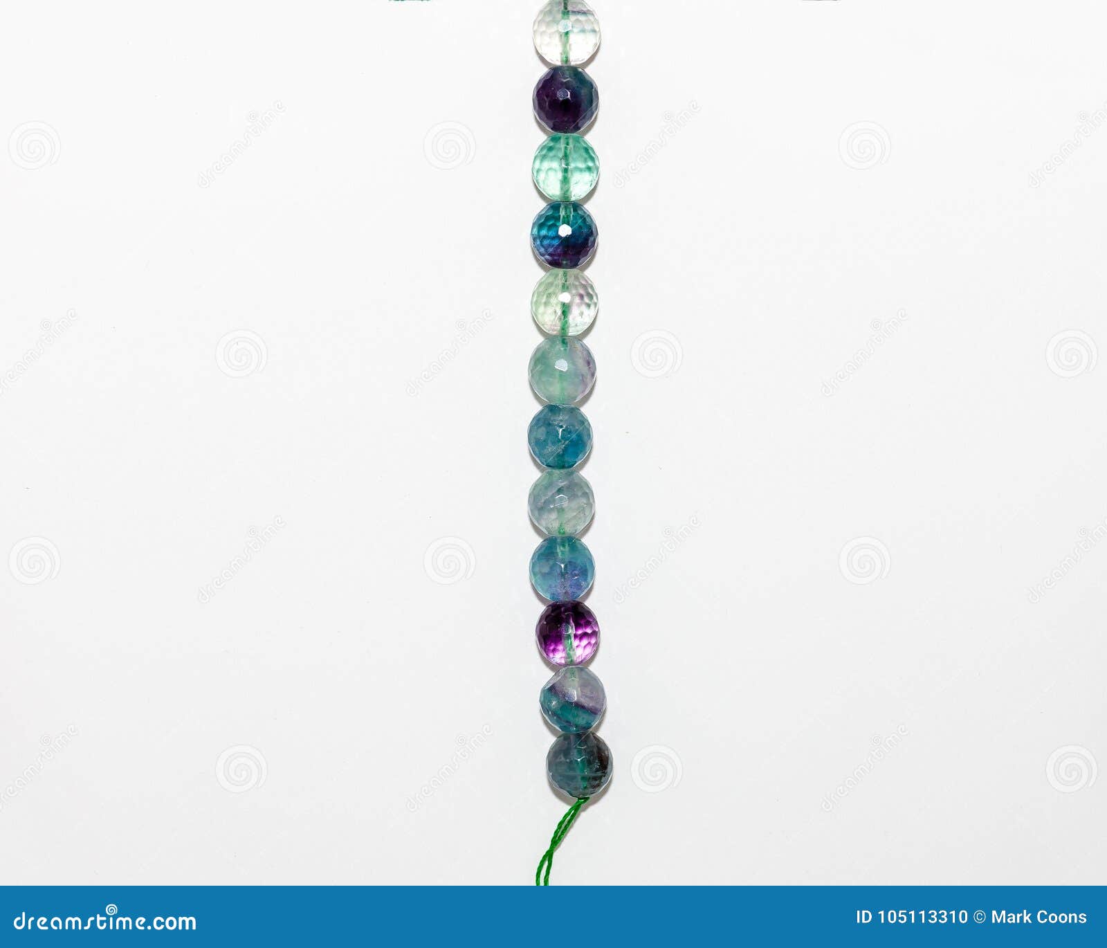 Strand of Medium Sized Round Multi Colored Beads on a Green String ...