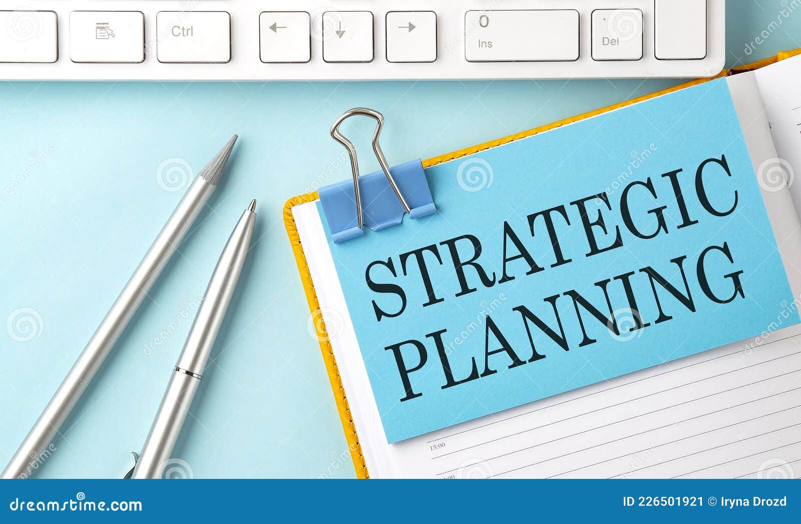 STRATEGIC PLANNING Text on Sticker on the Blue Background with Pen and ...