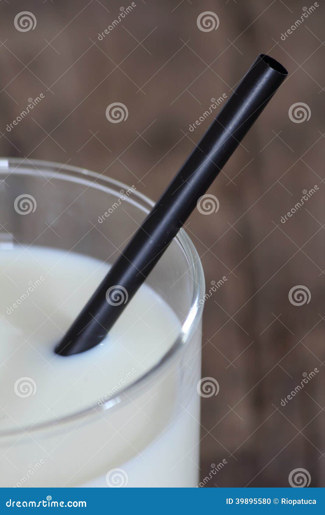 A straw in a glass of milk stock photo. Image of board - 39895580