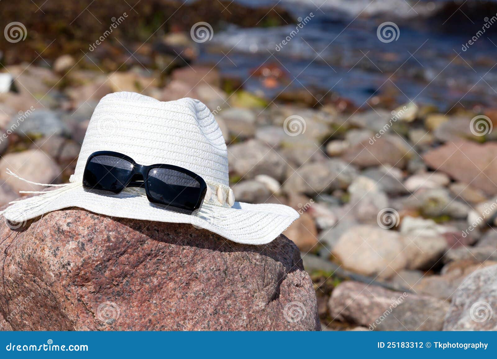 Straw hat on big rock stock photo. Image of rocks, rock - 25183312