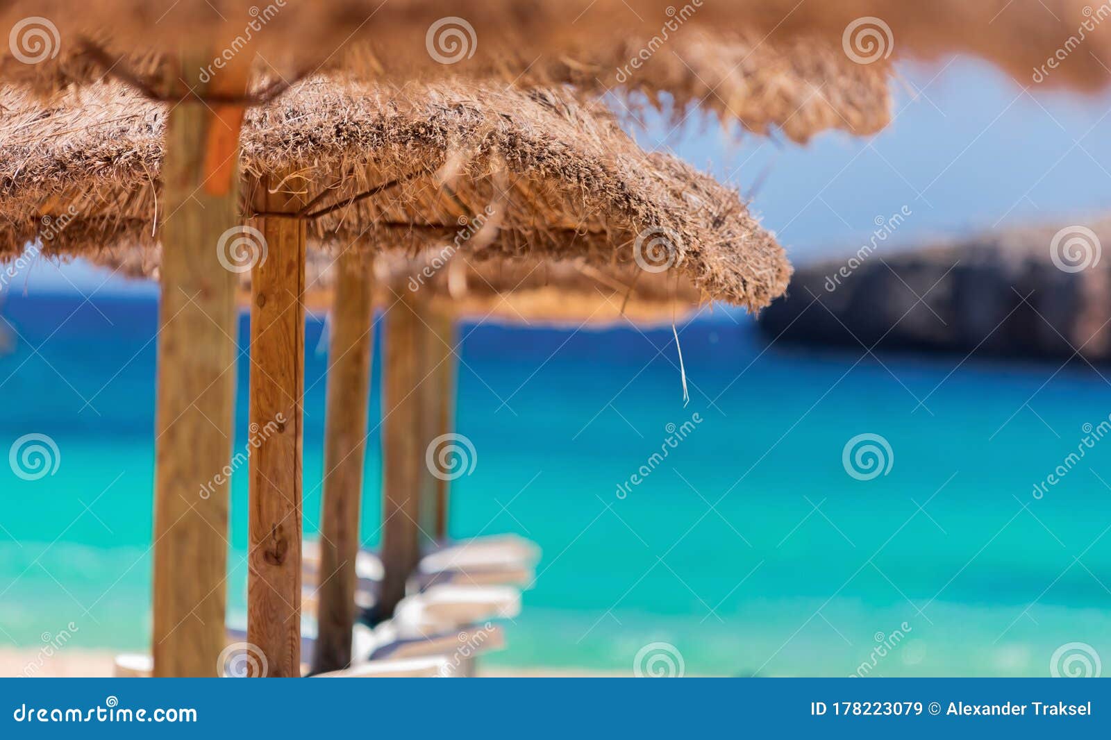 Straw Parasols and Beds on the Sandy Beach Stock Image - Image of beds ...