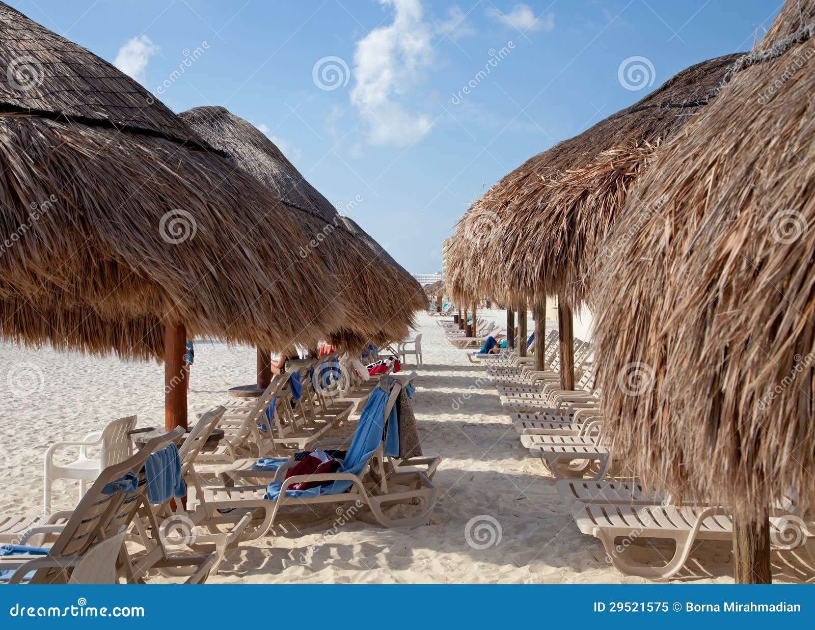 Straw Parasols and Sunbathing Chairs on the Beach Stock Image - Image ...