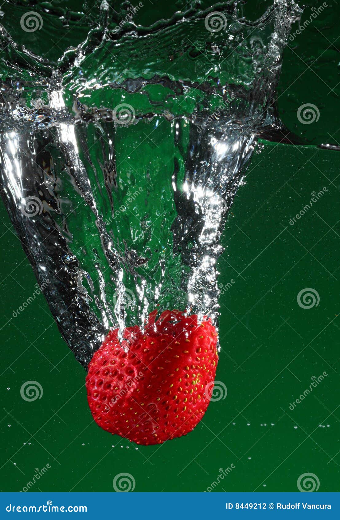 Strawberry Falling in Water Stock Photo - Image of background, green ...