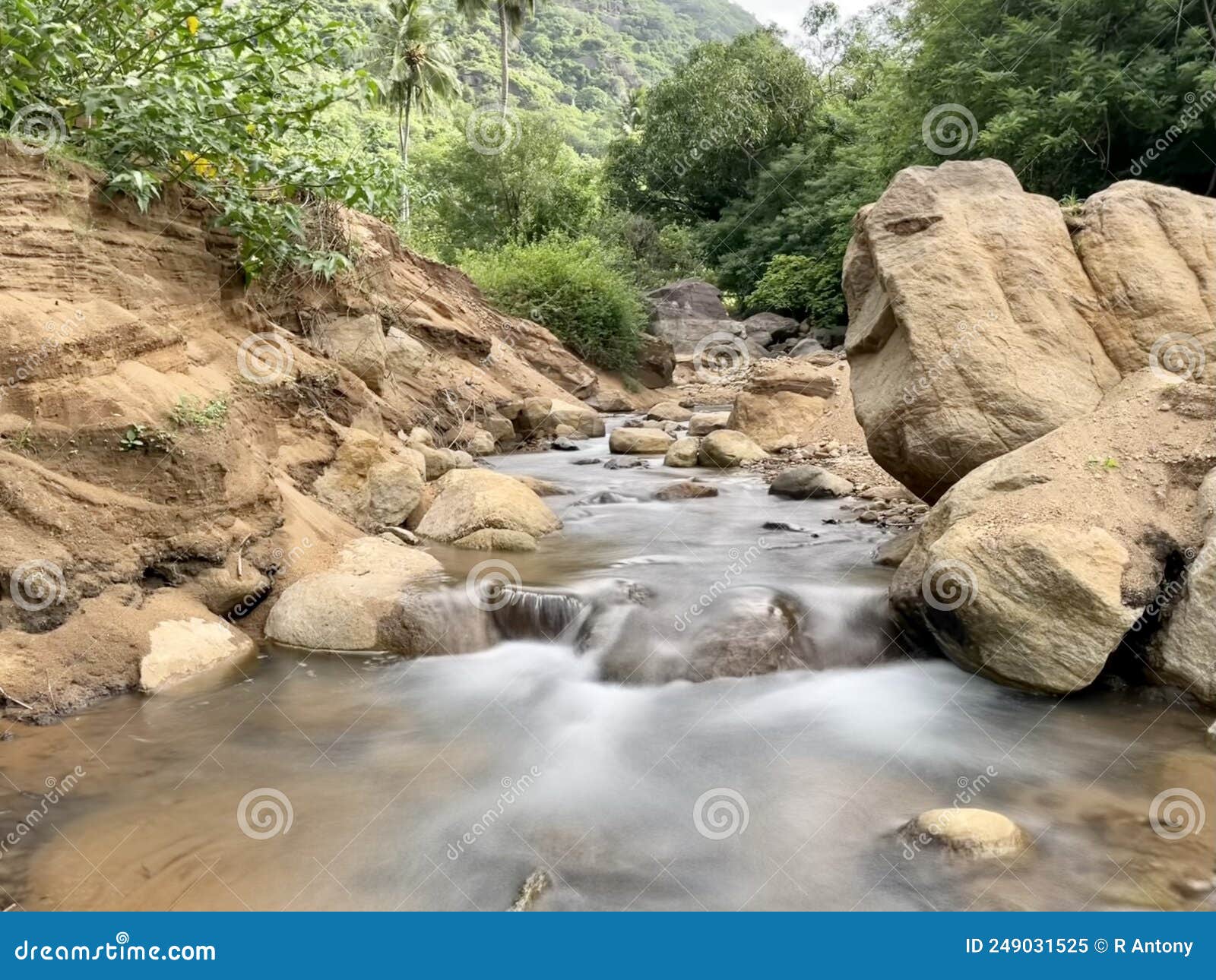 A Small Stream Coming Out from a Couple of Rocks Stock Image - Image of ...