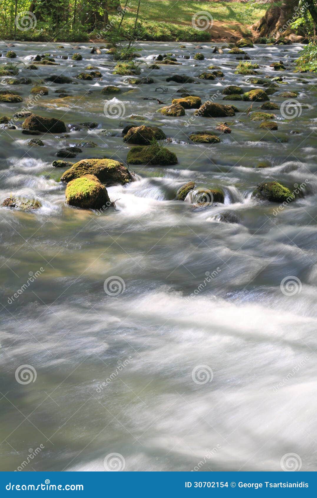 Stream flowing over rocks stock photo. Image of countryside - 30702154