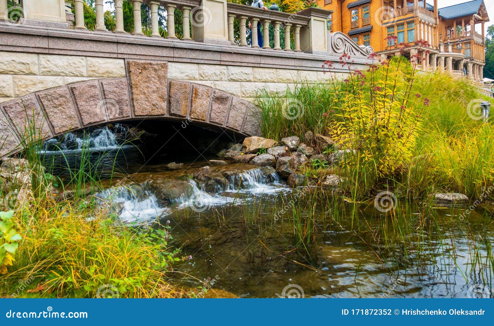 A Stream Flows from Under a Massive Brick Bridge Stock Photo - Image of ...