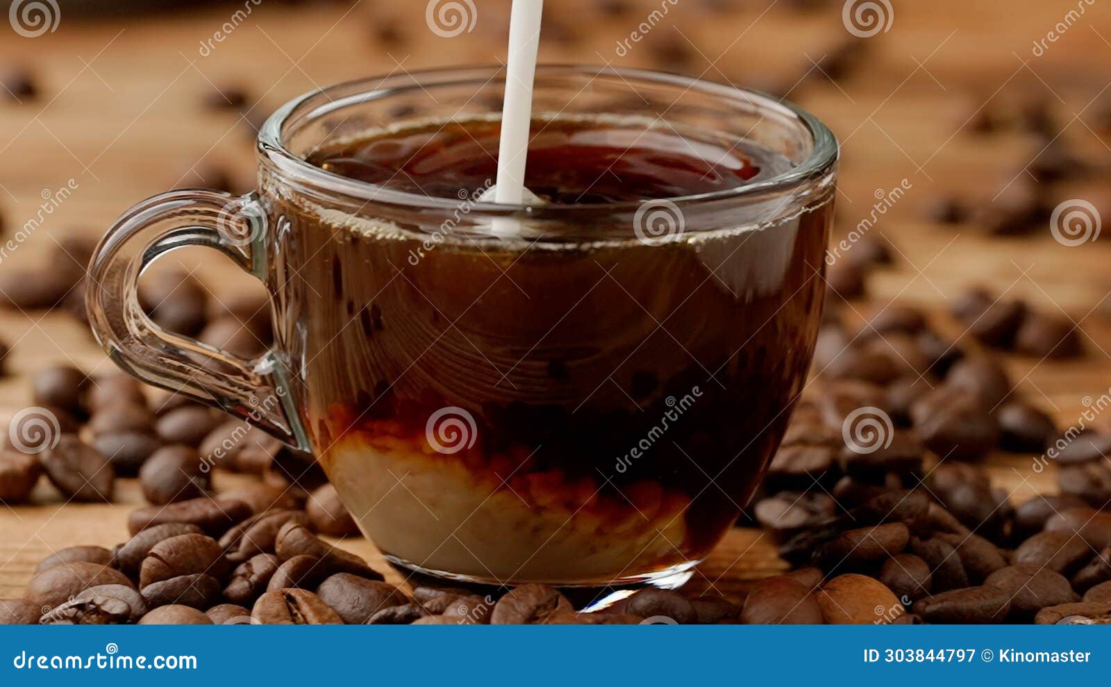 A Stream of Milk Pours into a Full Cup of Coffee and Dissolves into it ...