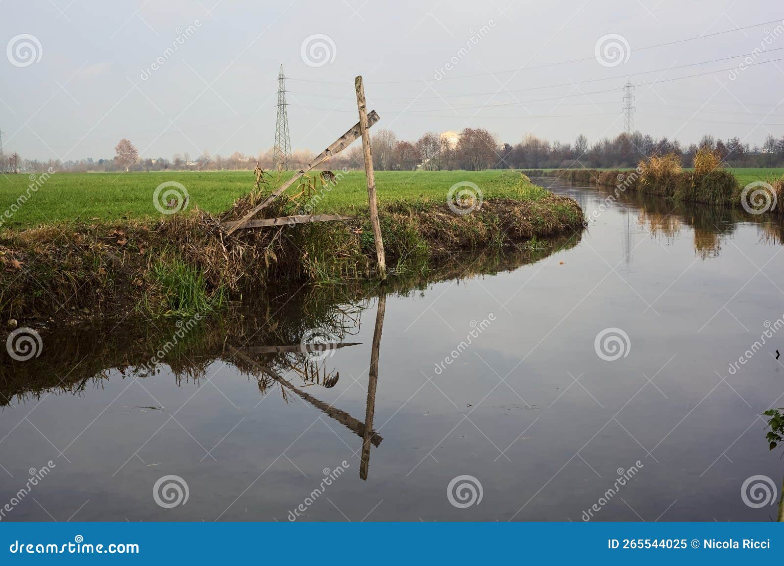 Stream of Water in the Countryside and a Mooring Pole by the Shore with ...