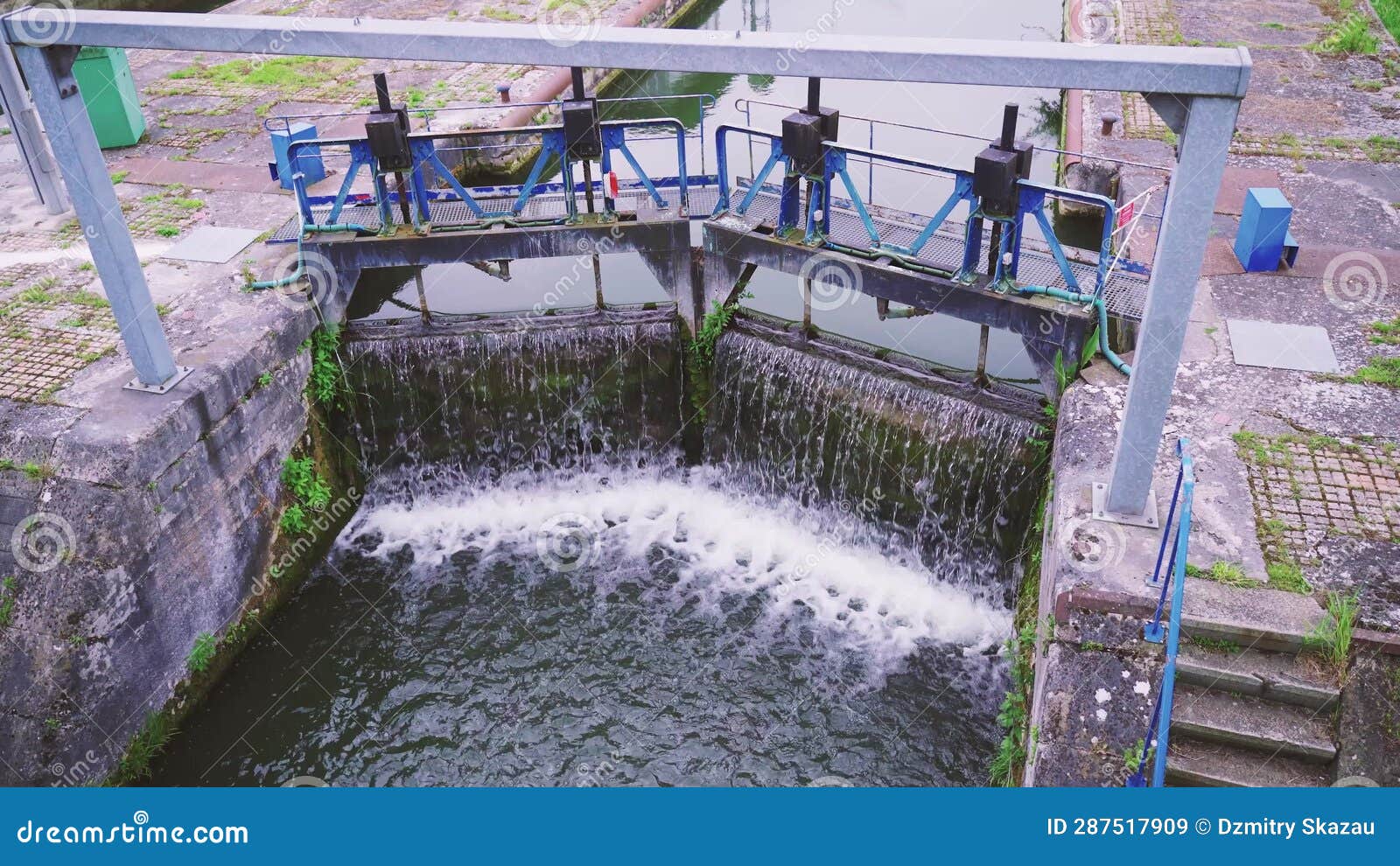 A Stream of Water Flows through the Closed Iron Gates of the Water ...
