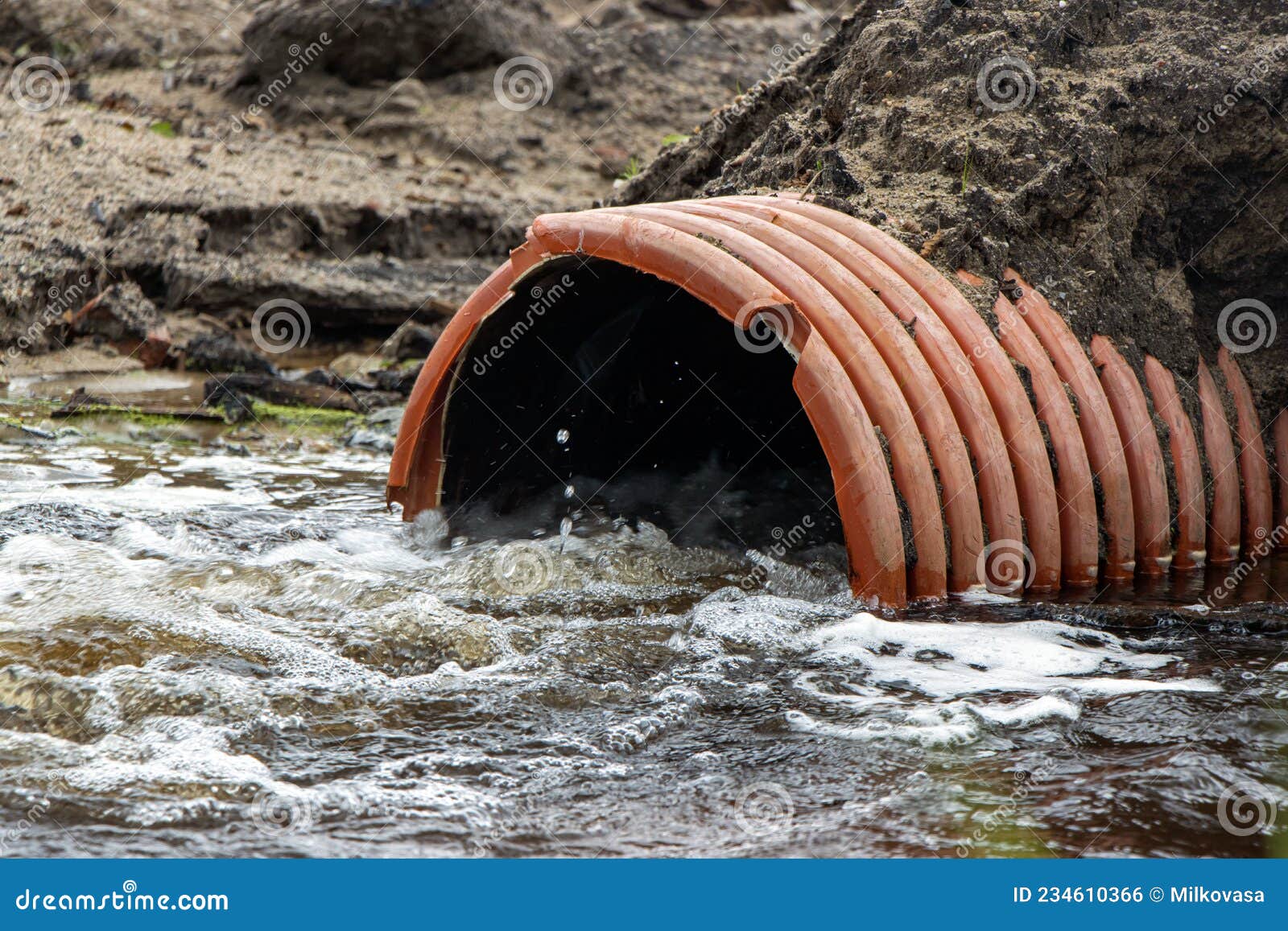 A Stream of Water Flows from a Large Flexible Pipe - Hose Stock Photo ...