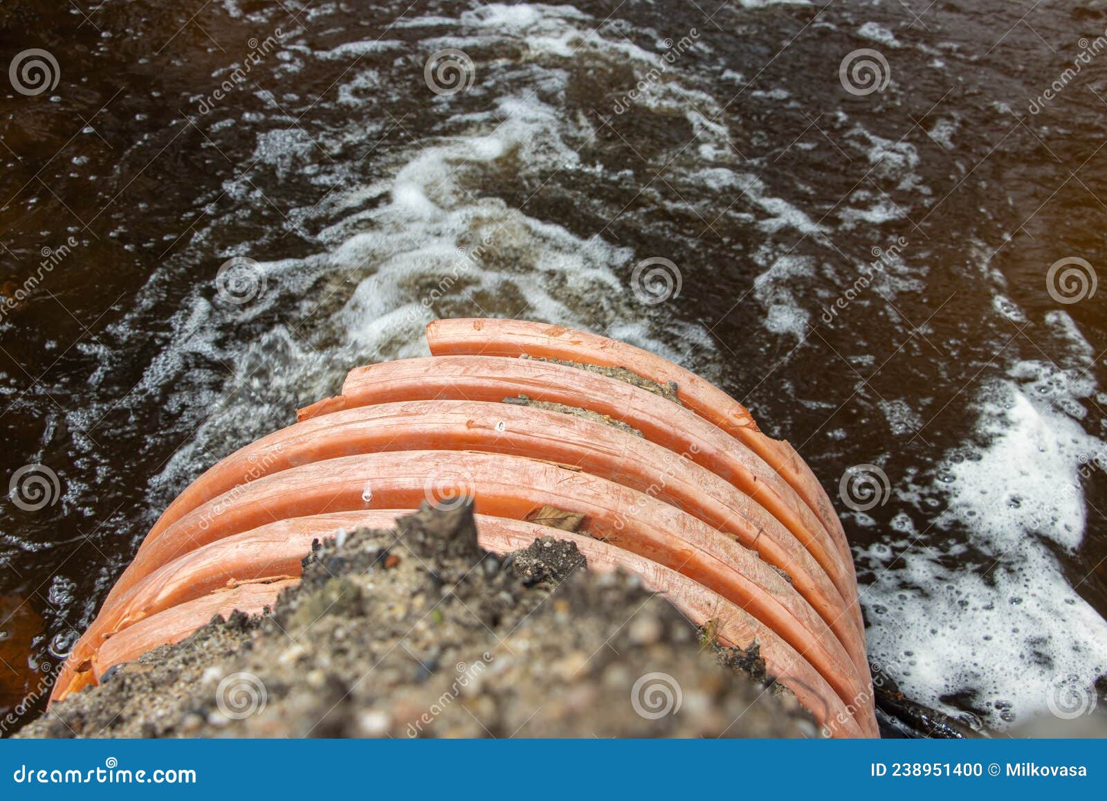 A Stream of Water Flows from a Large Flexible Pipe - Hose Stock Photo ...