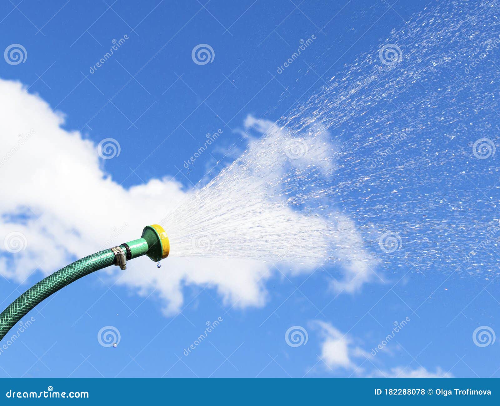 A Stream of Water from a Hose through a Diffuser Against the Blue Sky ...