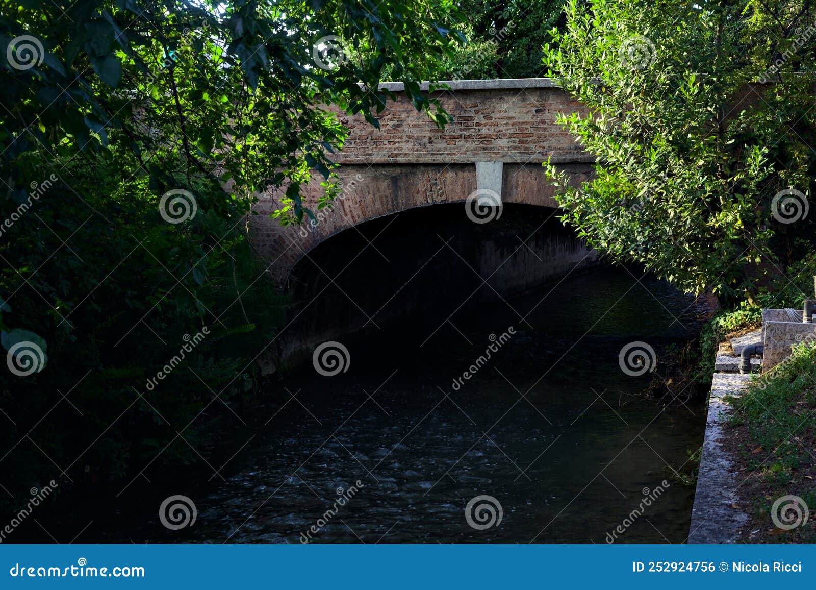 Stream of Water in the Shade with a Brick Bridge Stock Photo - Image of ...