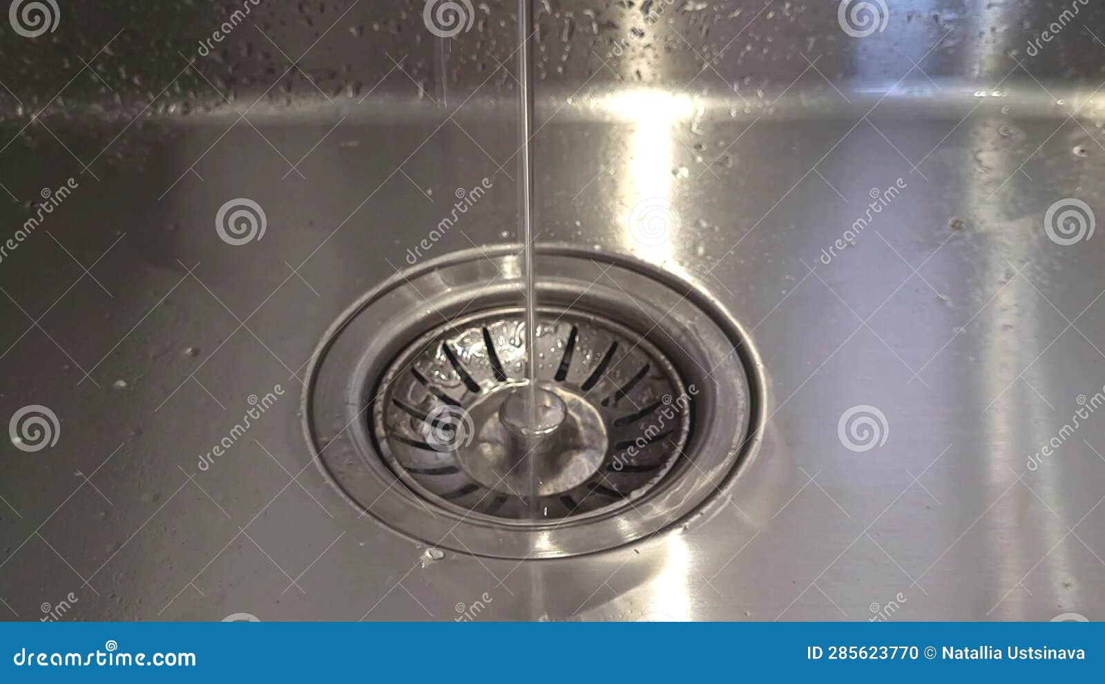 Streaming Water in Sink. Water Stream Going Down the Drain Stock ...
