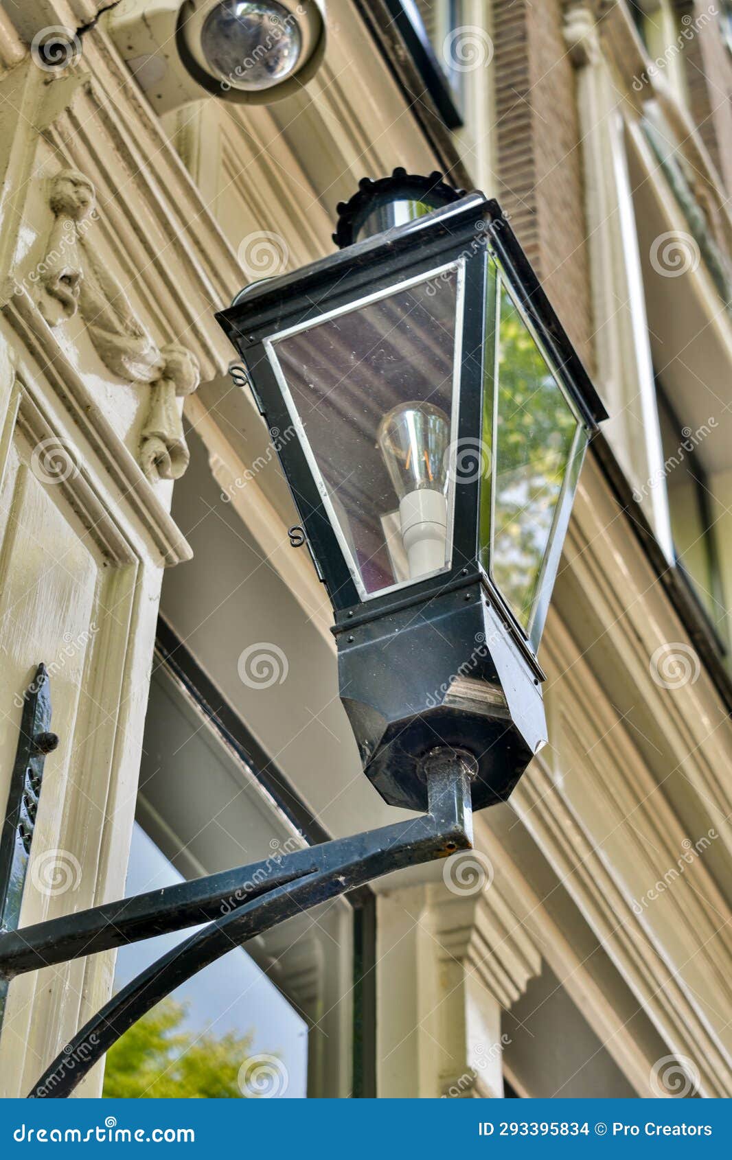 A Street Light on the Side of a Building Stock Photo - Image of glass ...