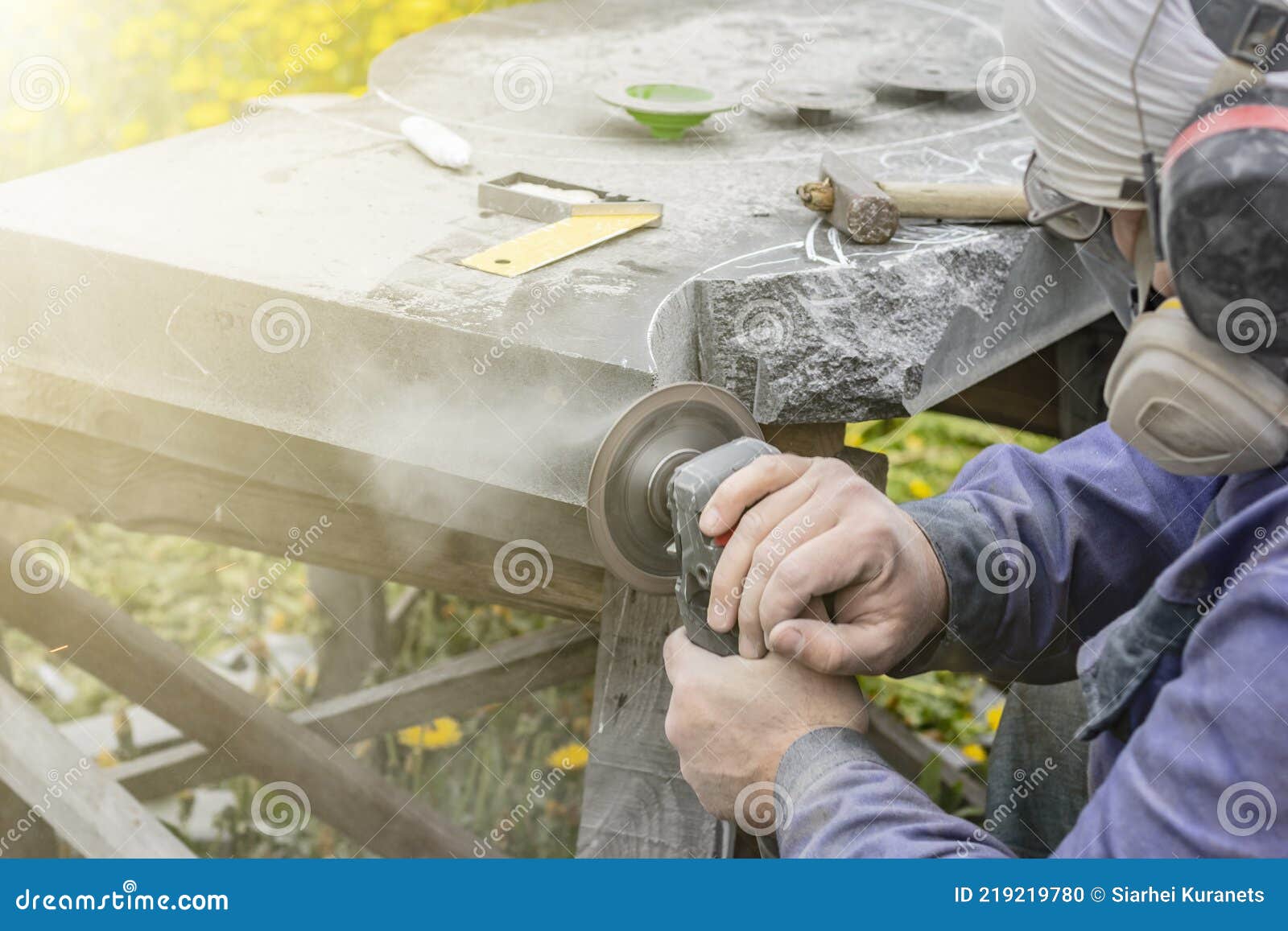 Street Lighting. a Masked Worker Processes a Granite Stone with a ...