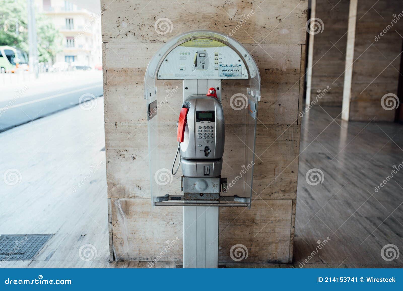 Street phone near a wall stock image. Image of device - 214153741