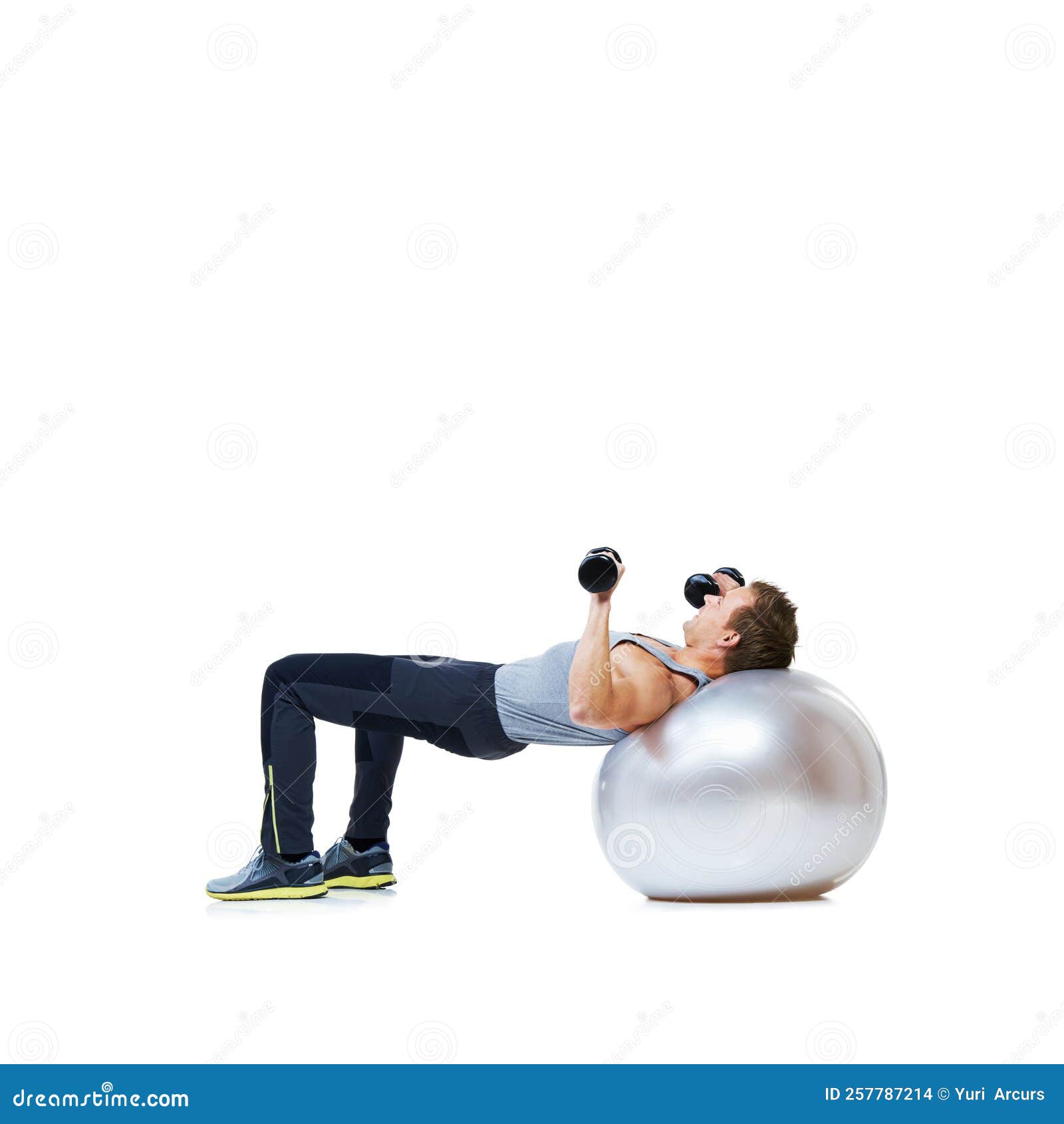 Strength and Determination. a Man Balancing on an Exercise Ball Lifting ...