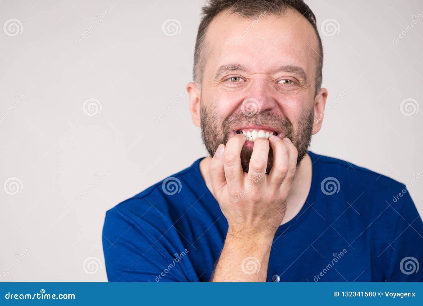 Man biting his nails stock photo. Image of nervous, stress - 132341580