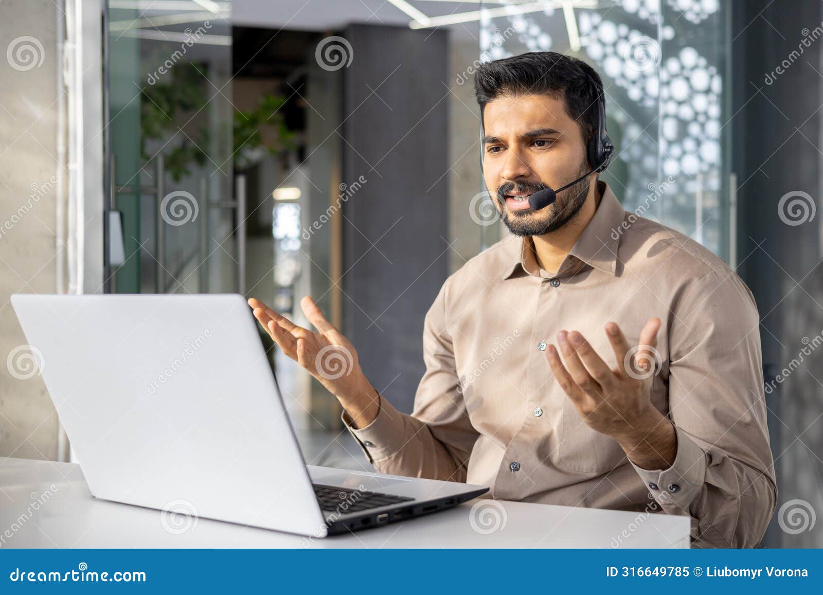Stressed Arab Male in Wireless Headset Spreading Hands Aside while ...