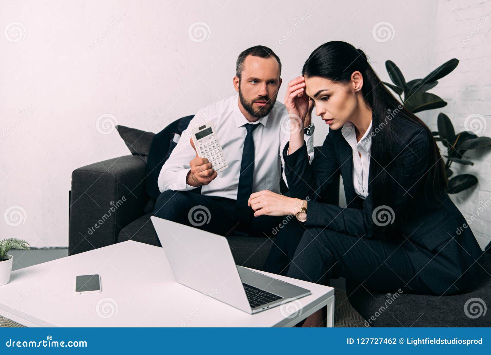 Stressed Business Colleagues Working Together at Coffee Table Stock ...