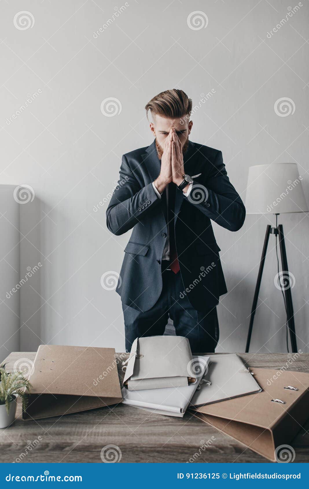 Stressed Businessman with Documents and Folders Standing at Table in ...