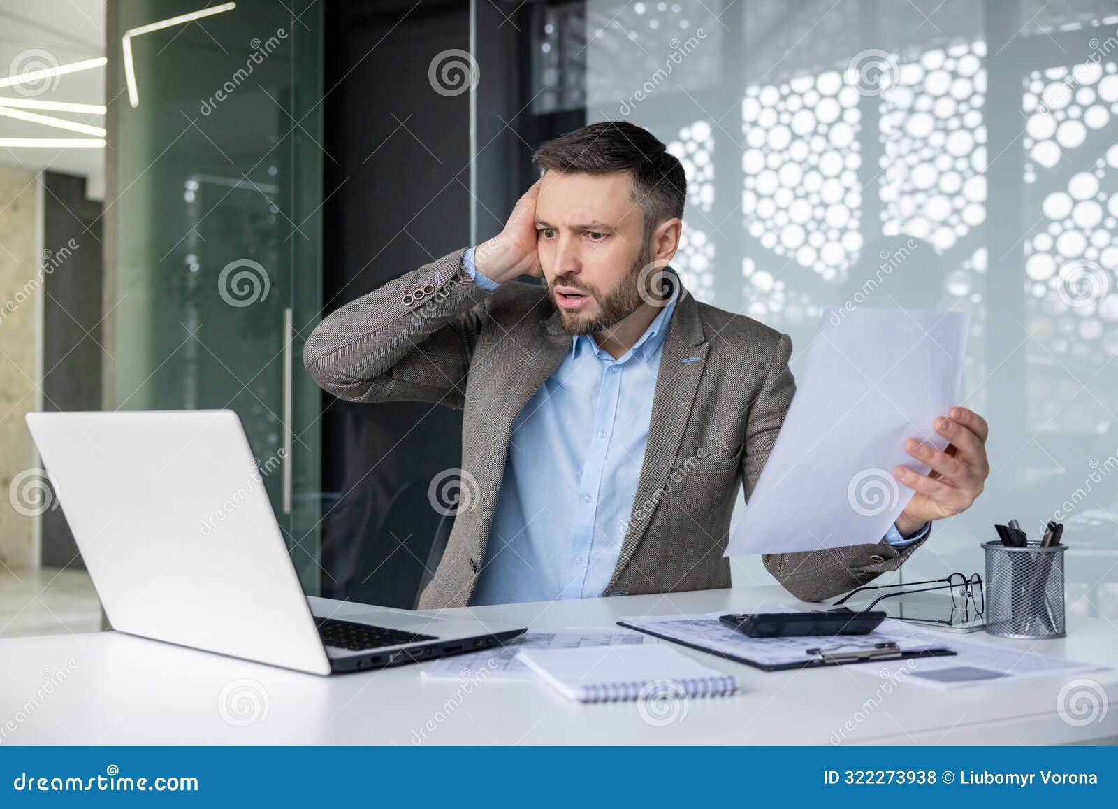 Stressed Businessman Reviewing Documents in Modern Office while Working ...