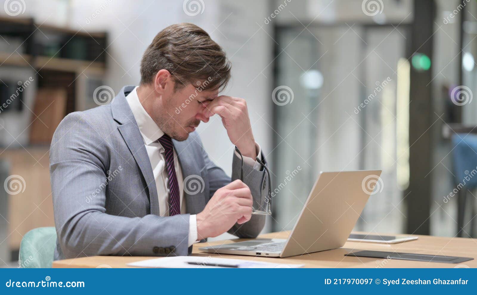 Stressed Businessman with Laptop Having Headache in Office Stock Image ...