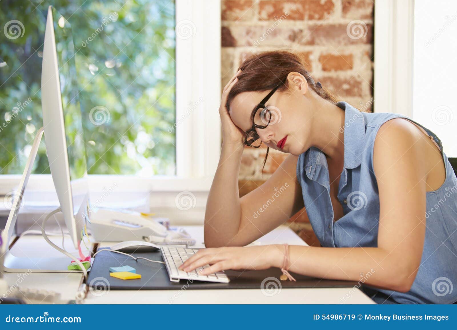 Stressed Businesswoman Working at Computer in Modern Office Stock Image ...