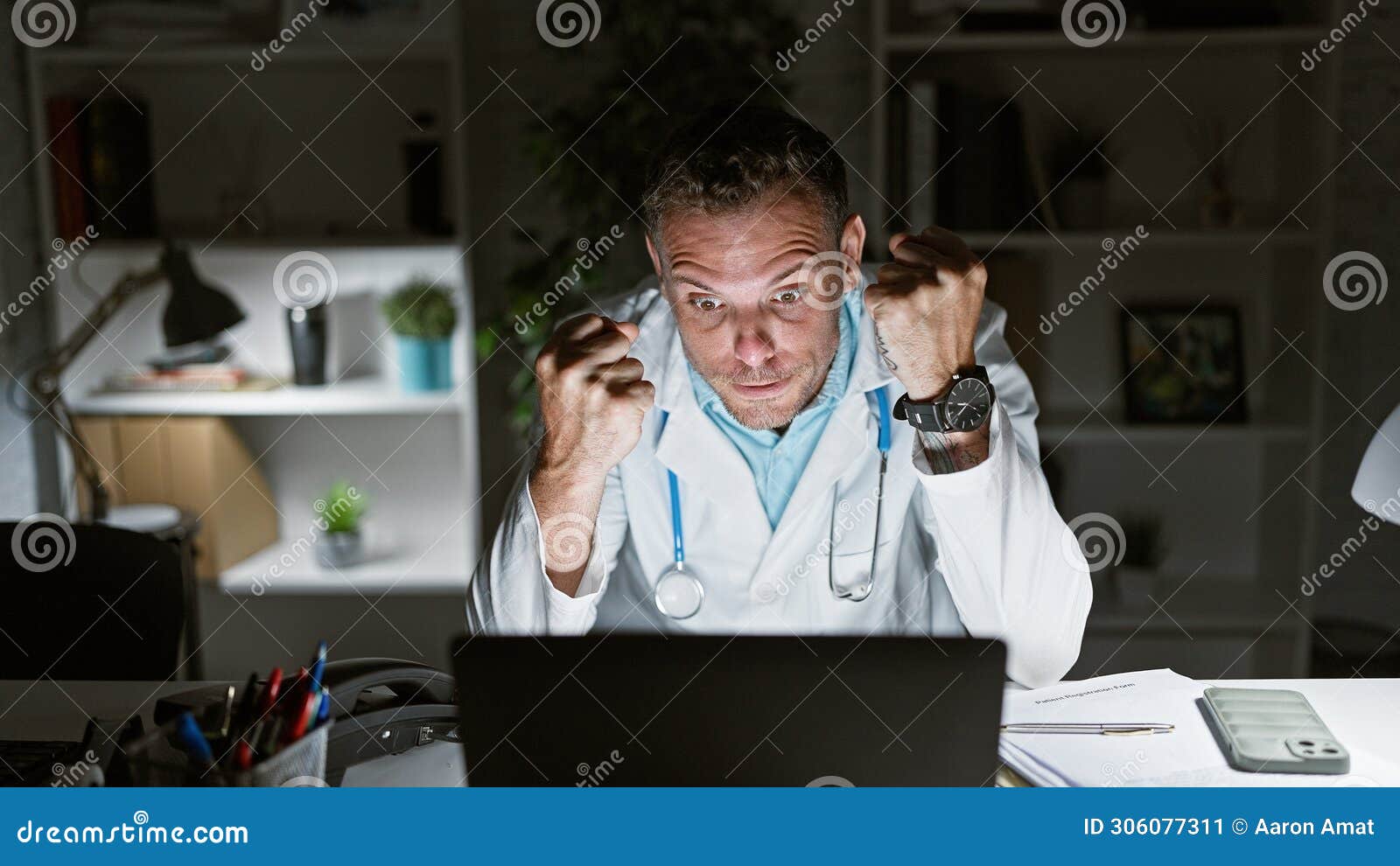 Stressed Doctor in Clinic Office Working Late with Computer and ...