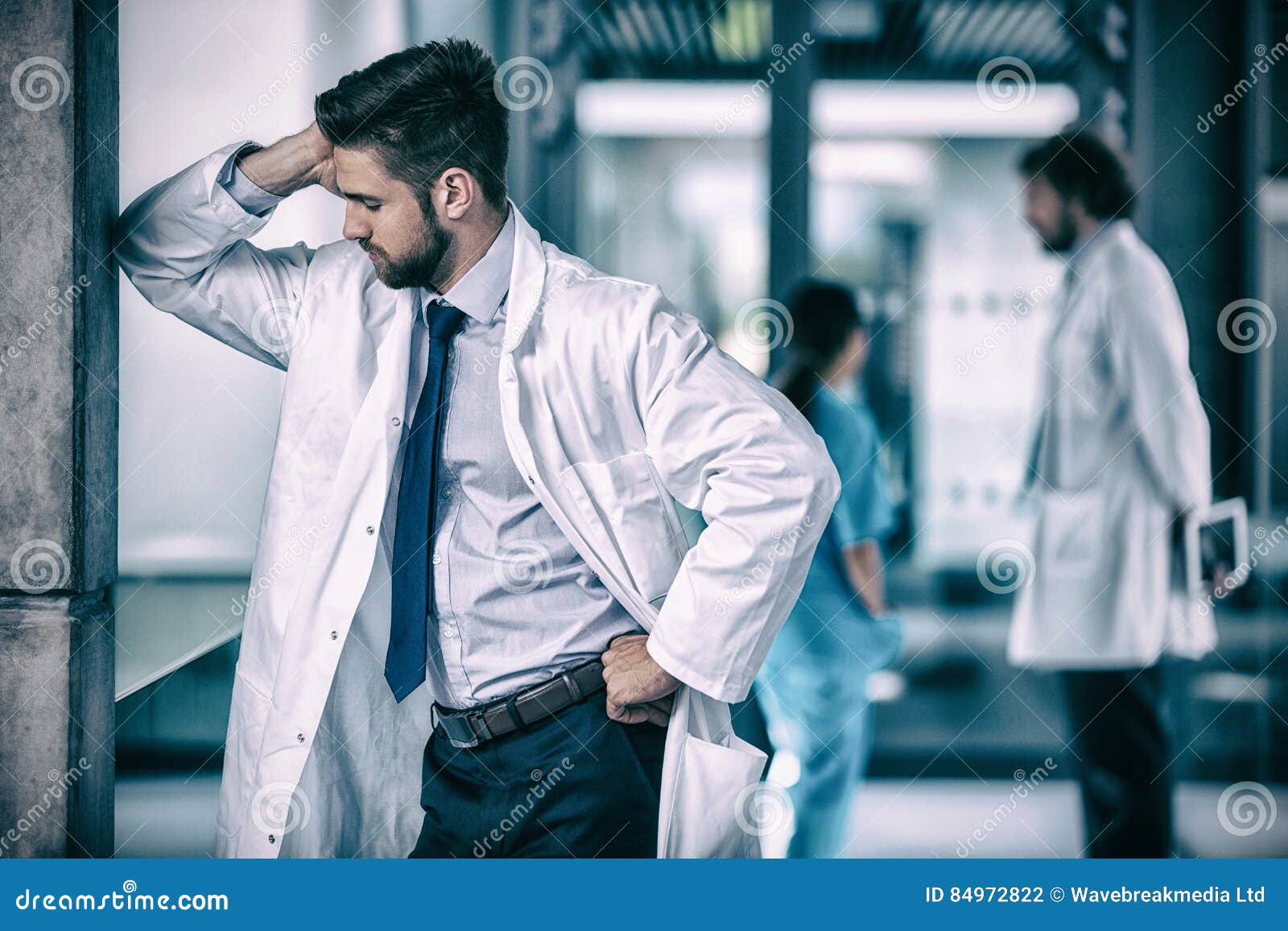 Stressed Doctor Standing in Hospital Stock Photo - Image of expertise ...
