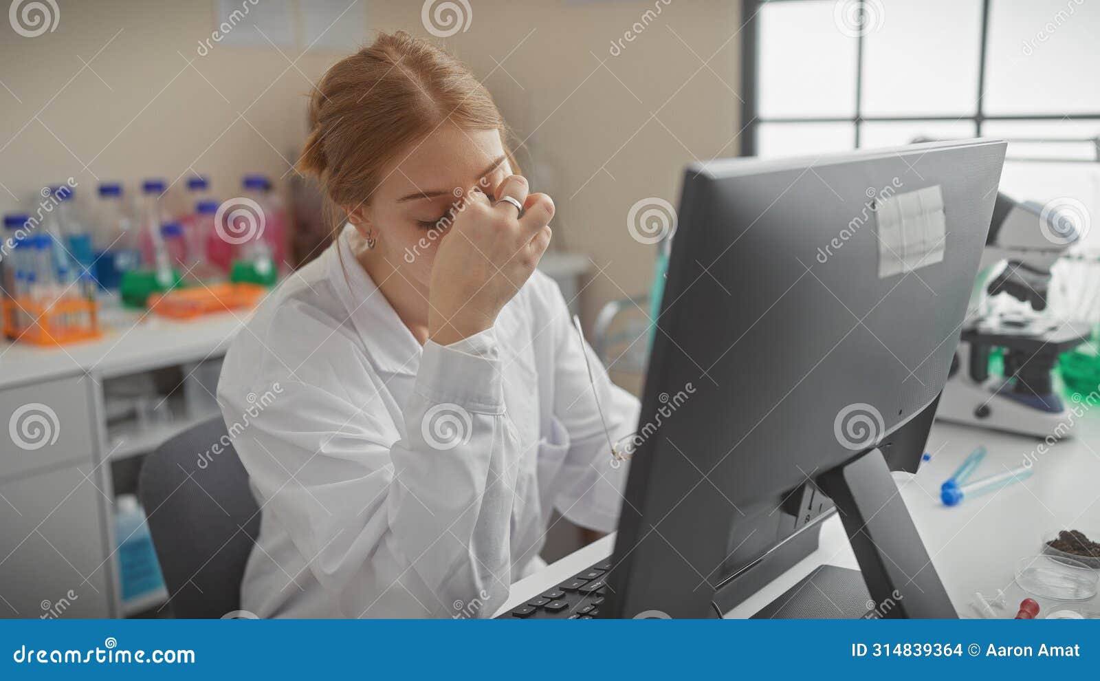 Stressed Female Scientist in Lab Experiencing Fatigue in Front of ...