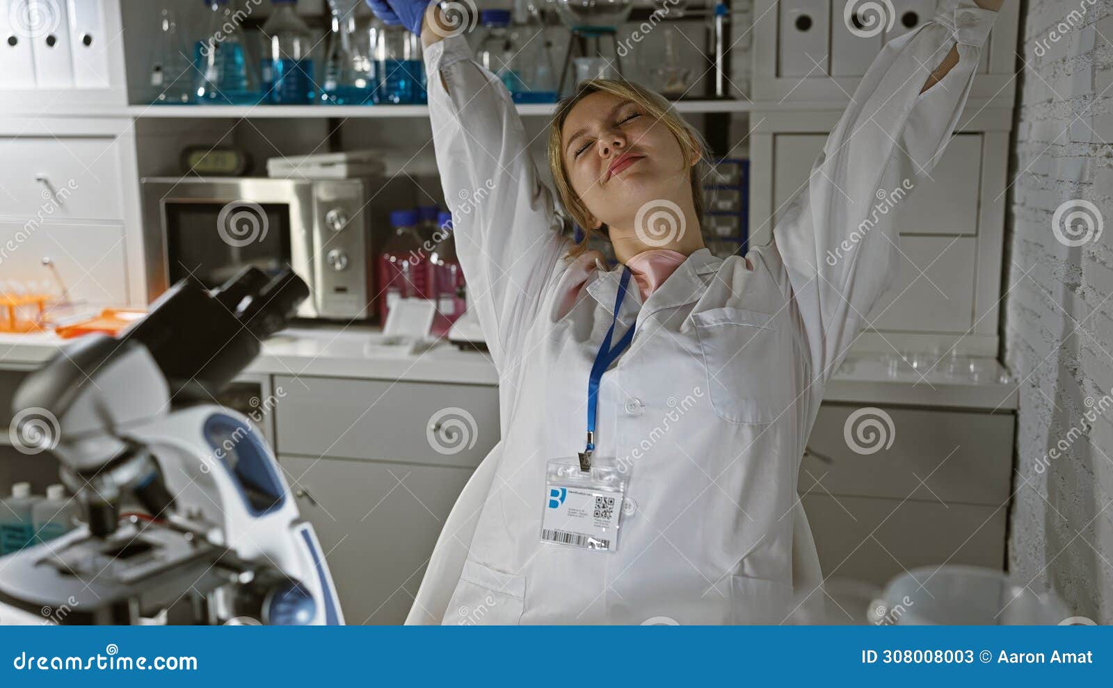 Stressed Female Scientist Stretching in a Laboratory with Microscope ...