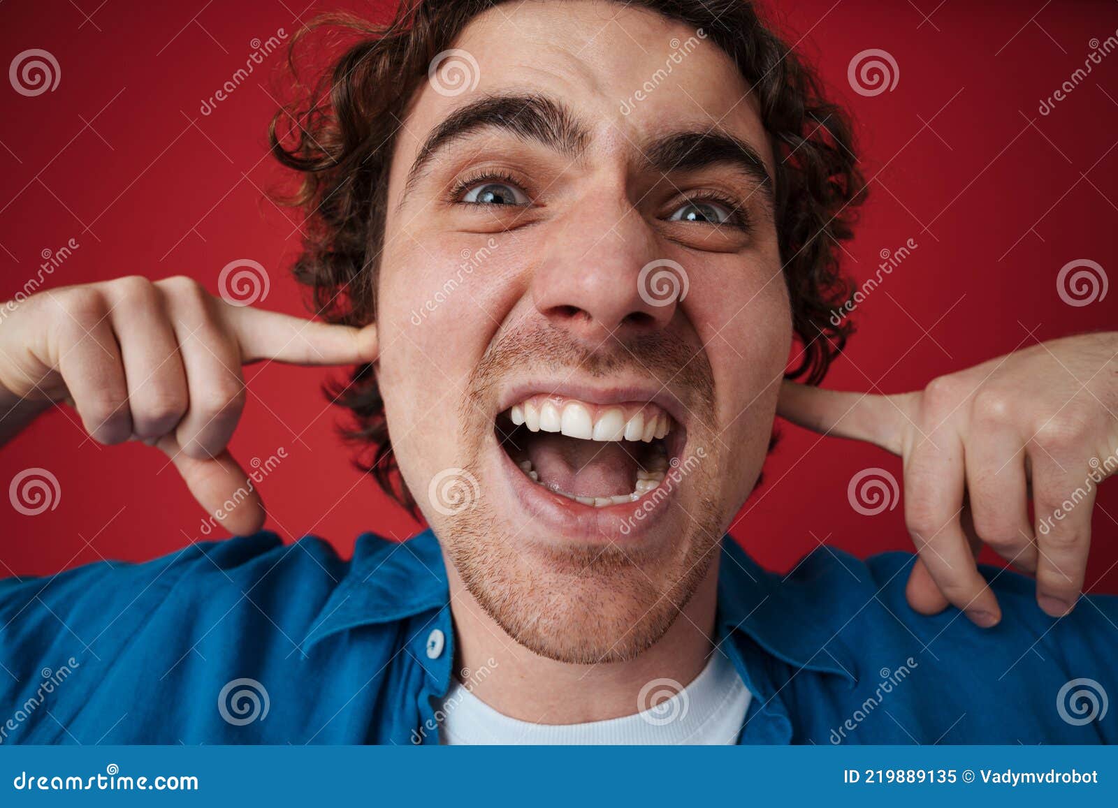 Stressed Handsome Man Screaming while Plugging His Ears Stock Image ...