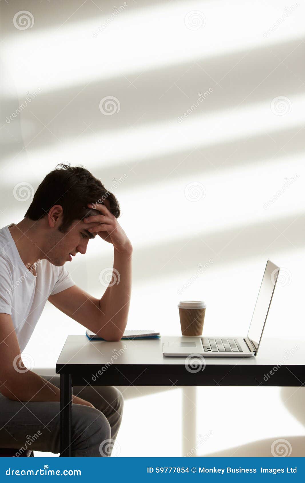 Stressed Male College Student Using Computer in Classroom Stock Photo ...
