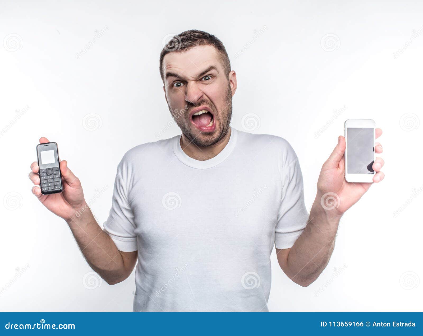 Stressed Man is Holding Two Different Phones Made in Different Years ...