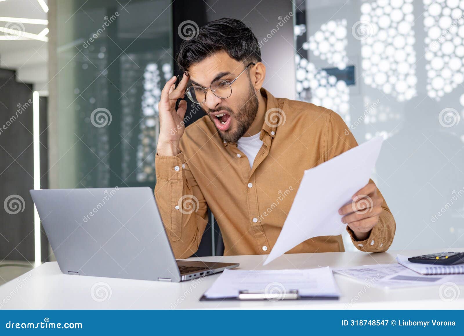 Stressed Man Overwhelmed by Work at Office Desk, Looking at Laptop and ...
