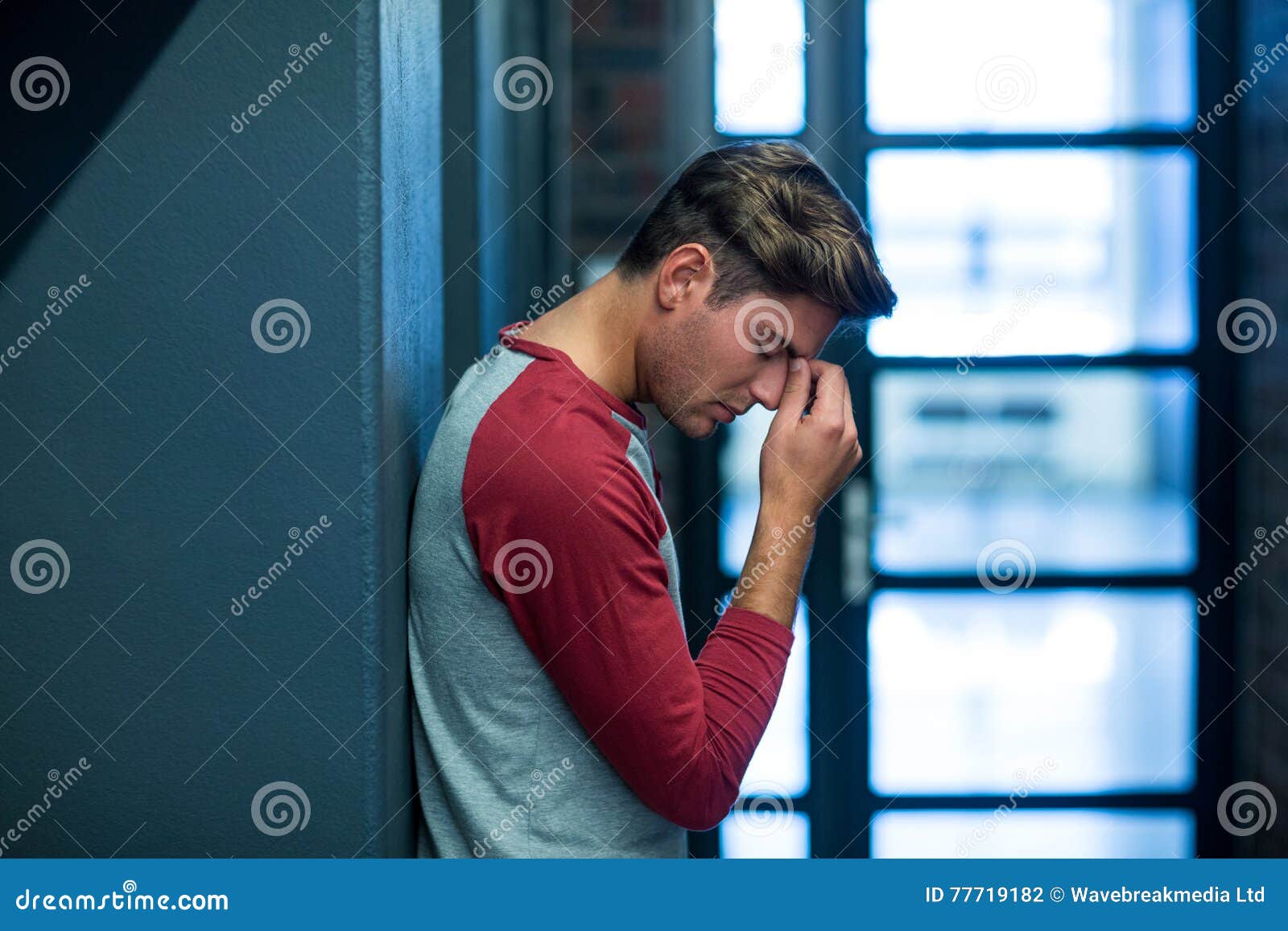 Stressed man by window stock photo. Image of focus, depressed - 77719182