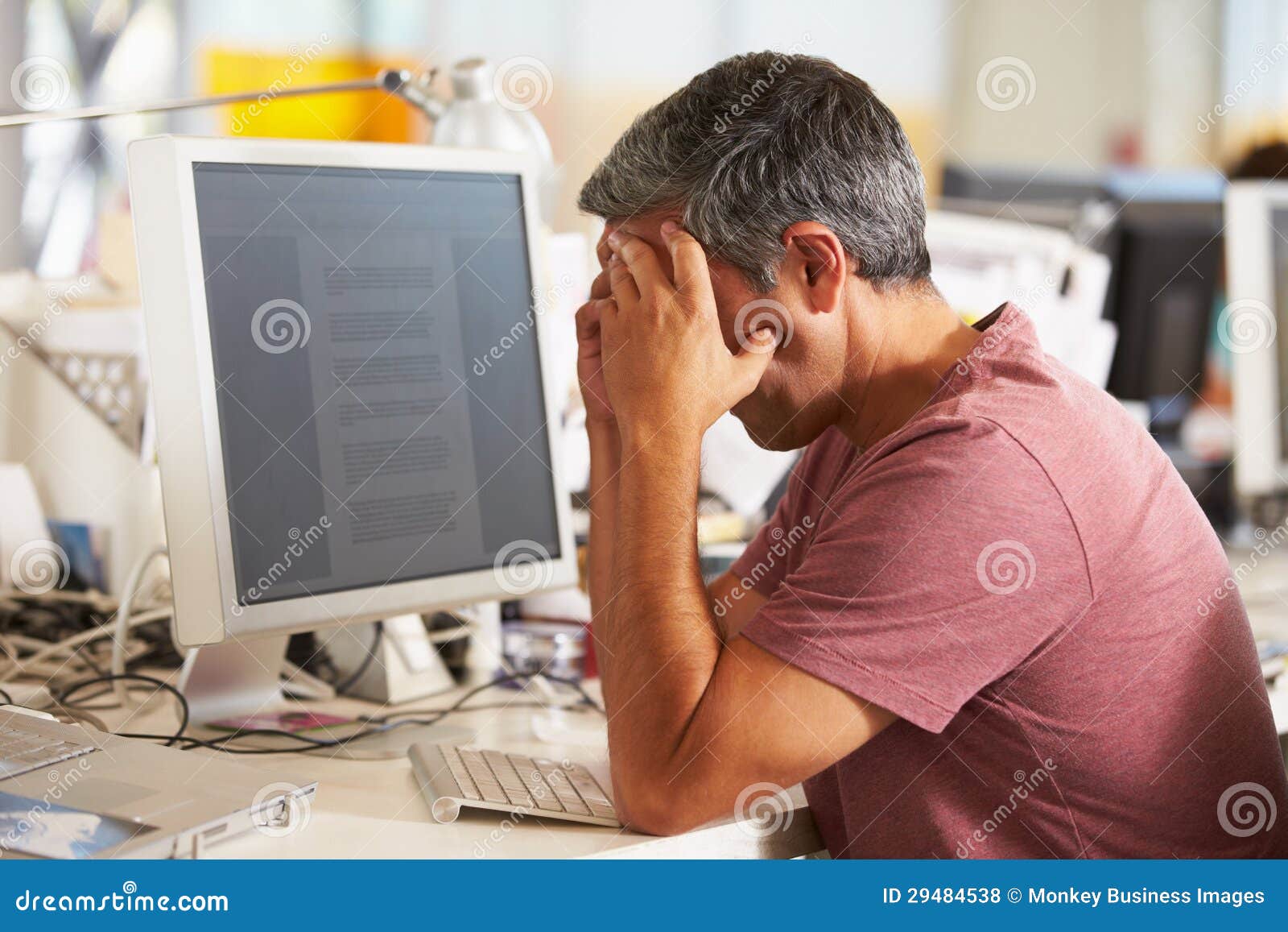 Stressed Man Working at Desk in Busy Creative Office Stock Photo ...