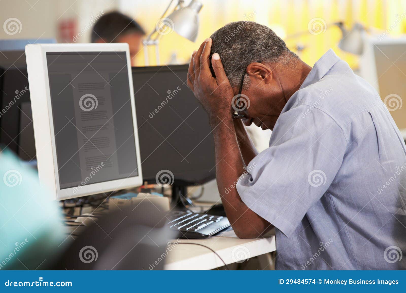 Stressed Man Working at Desk in Busy Creative Office Stock Photo ...