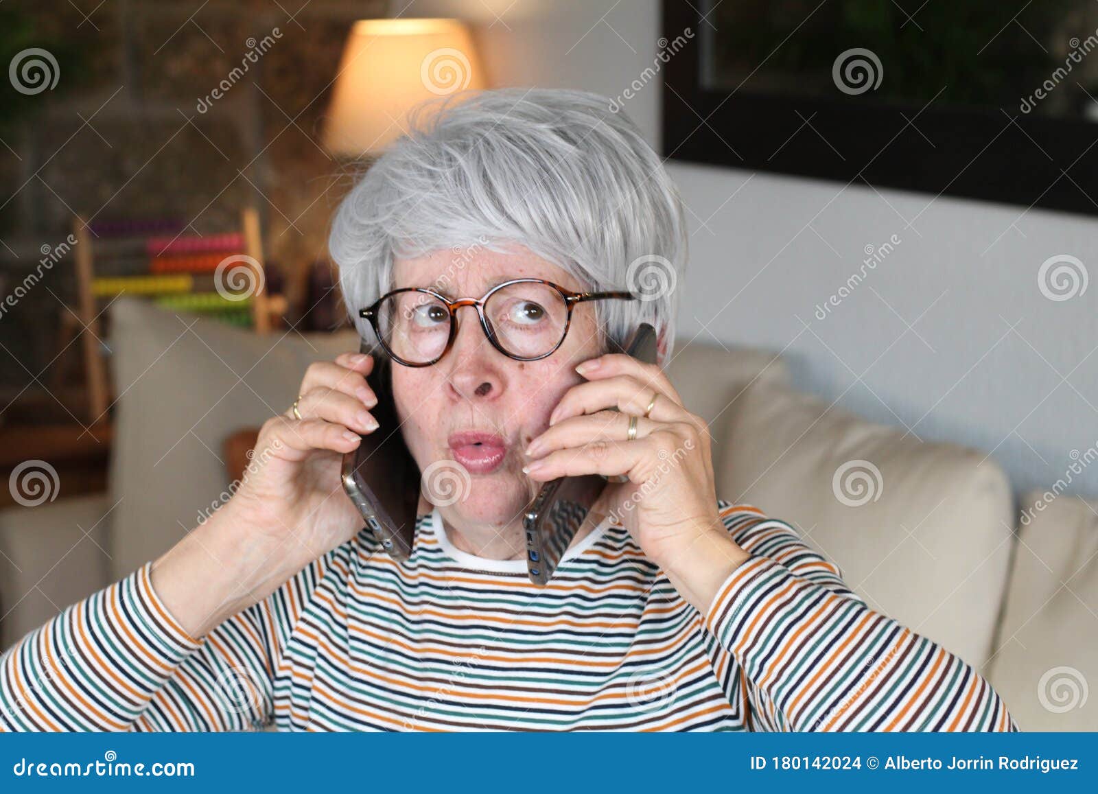 Stressed Senior Woman Using Two Phones Simultaneously Stock Photo ... Stressed Senior Woman Using Two Phones Simultaneously Stock Photo ...