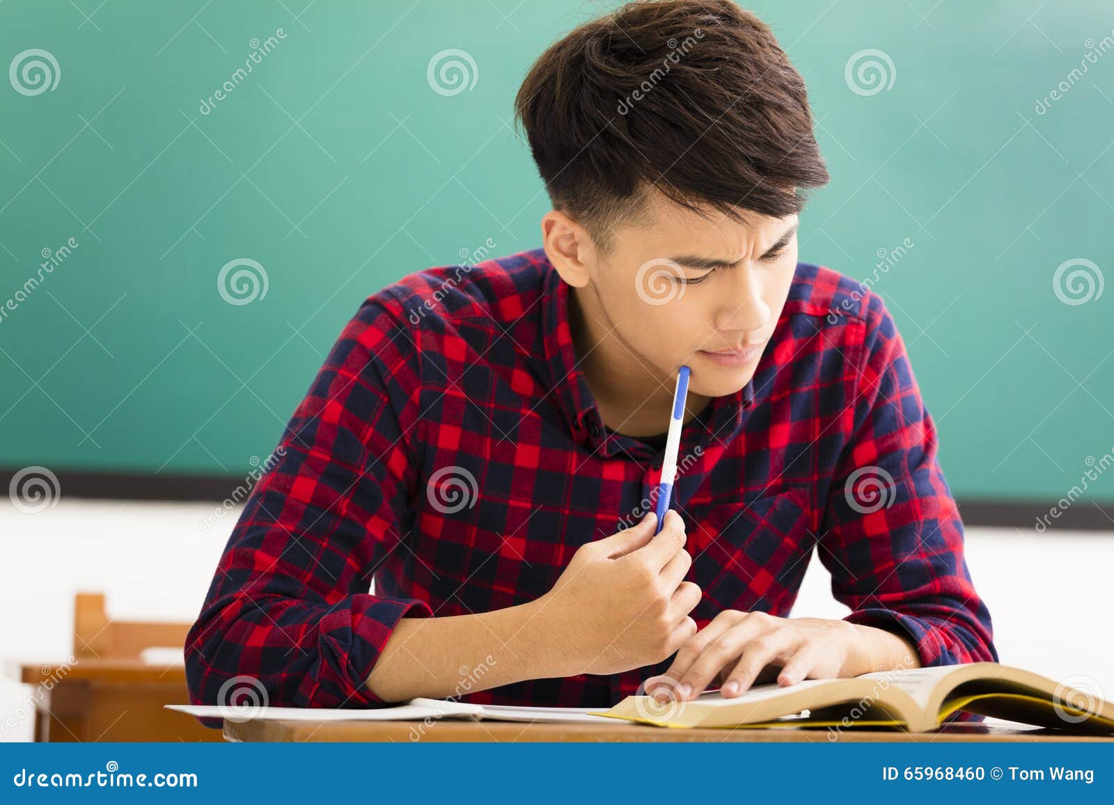 Stressed Student Studying for Exam in Classroom Stock Photo - Image of ...