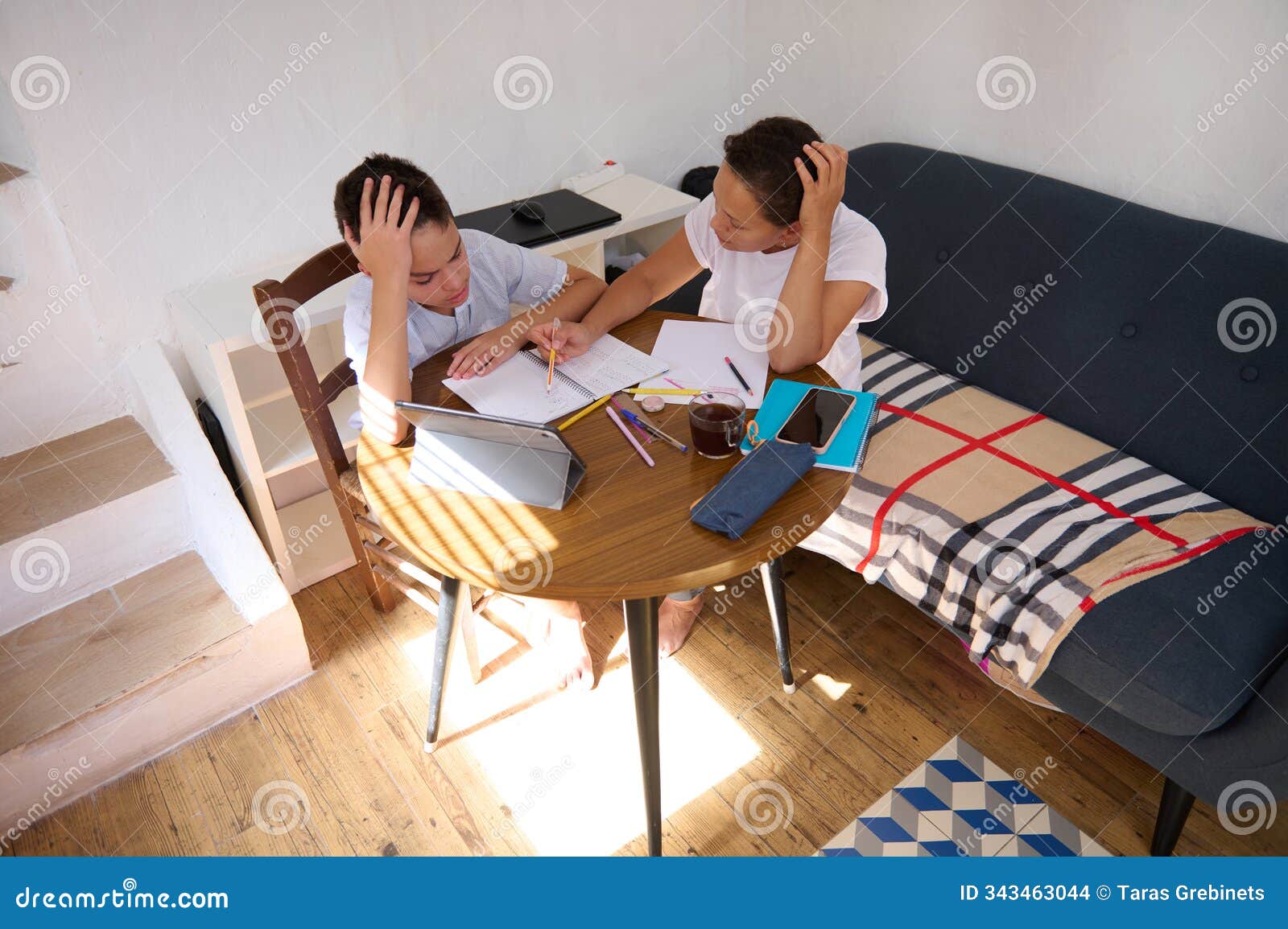 Stressed Students Collaborating on Homework at Home Table Stock Photo ...