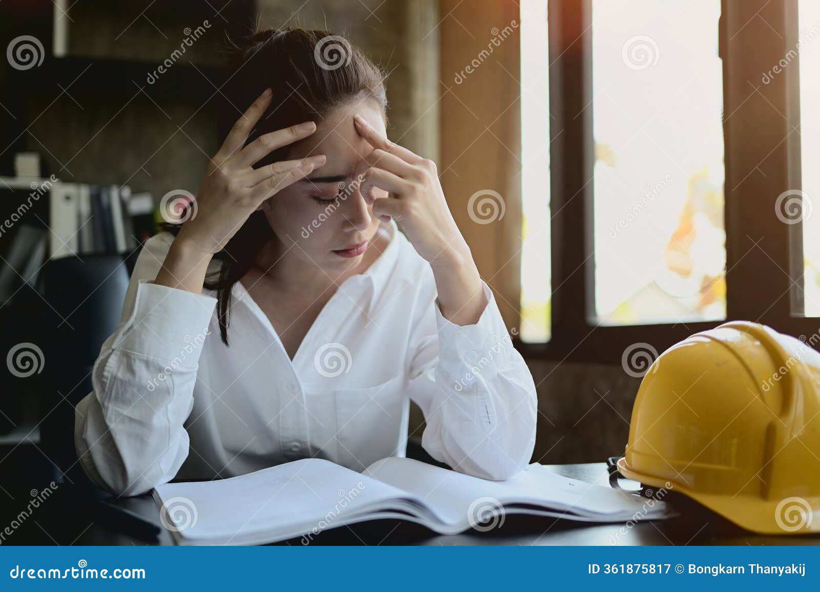 A Stressed, Tired Asian Female Architect or Engineer Boss Sits at Her ...