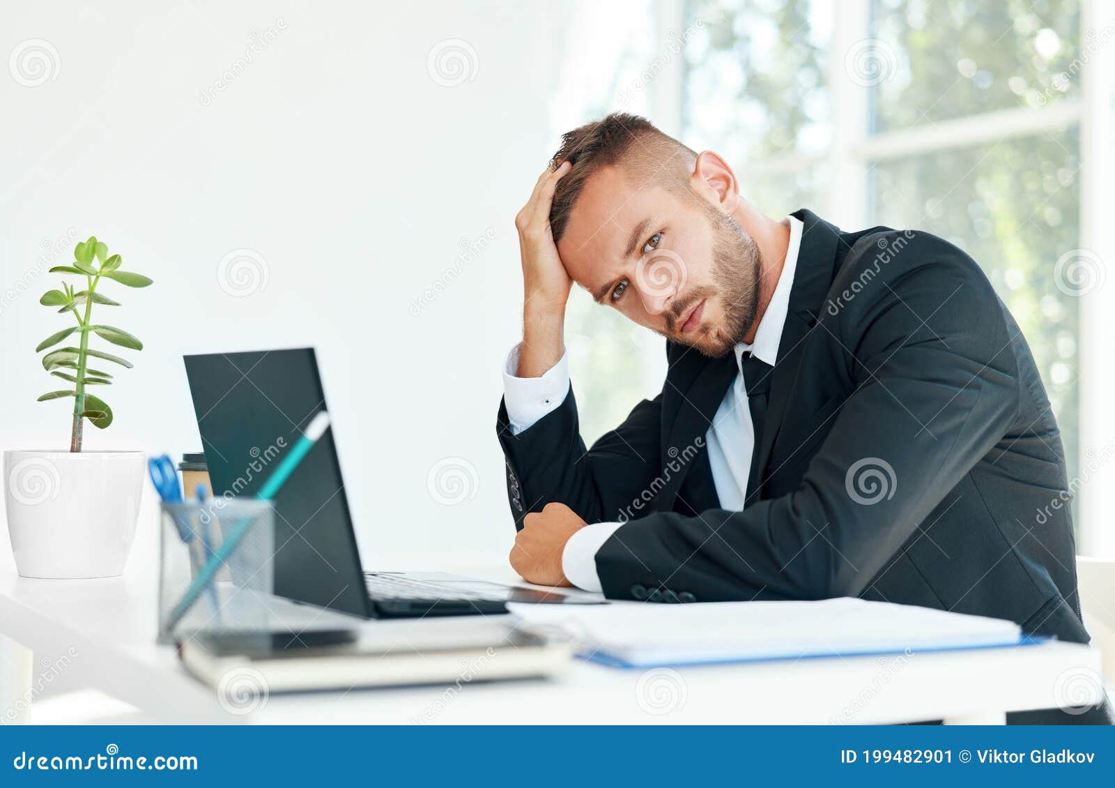 Stressed Tired Businessman Sitting at the Desk in Creative Office Stock ...